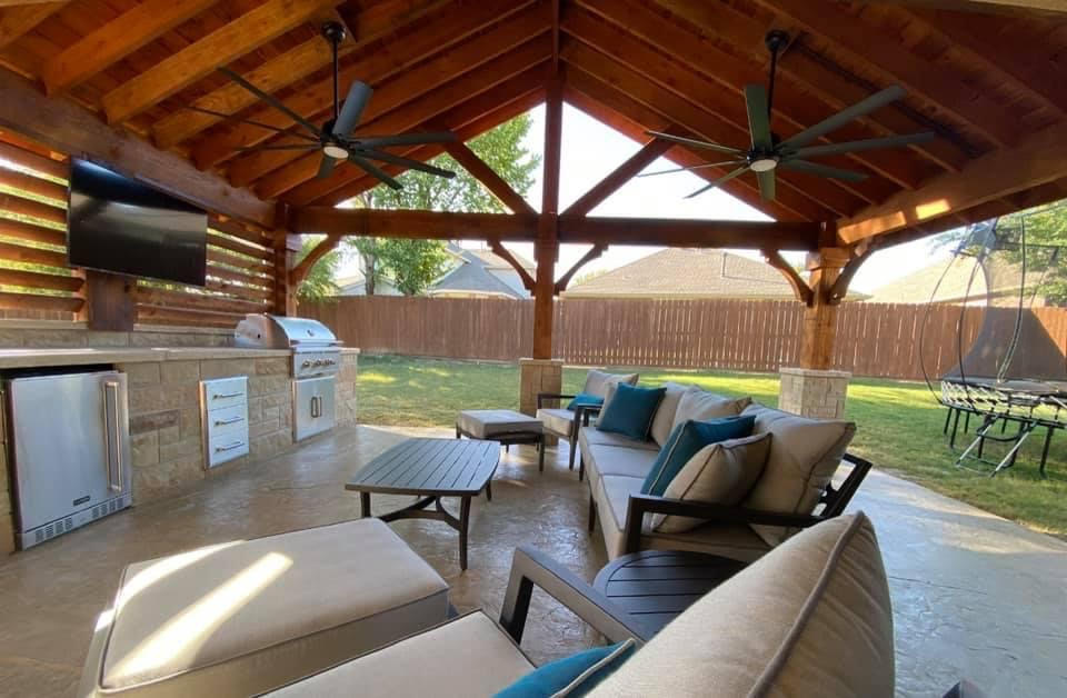 gable patio with leuder kitchen and privacy wall and stamped concrete ...